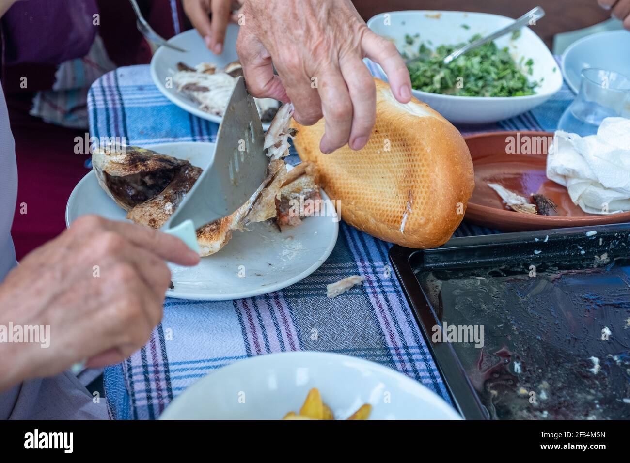 Family gathering to eat fish together Stock Photo - Alamy