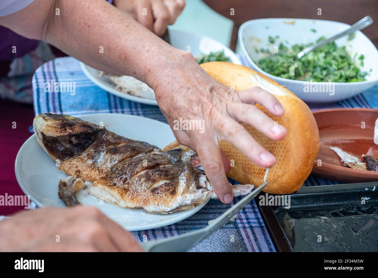 Family gathering to eat fish together Stock Photo - Alamy