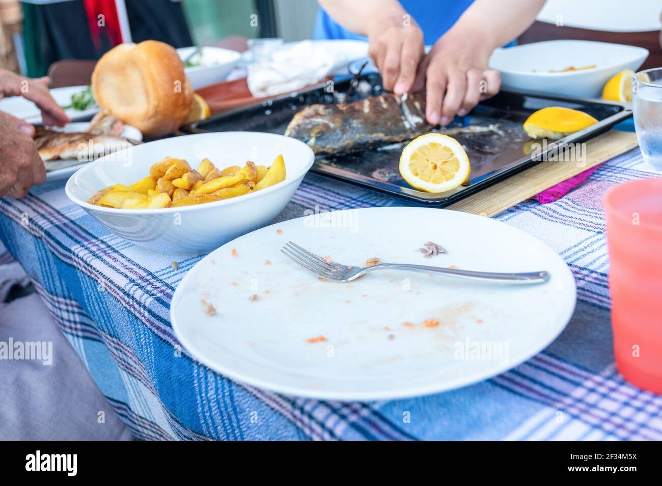 Family gathering to eat fish together Stock Photo - Alamy