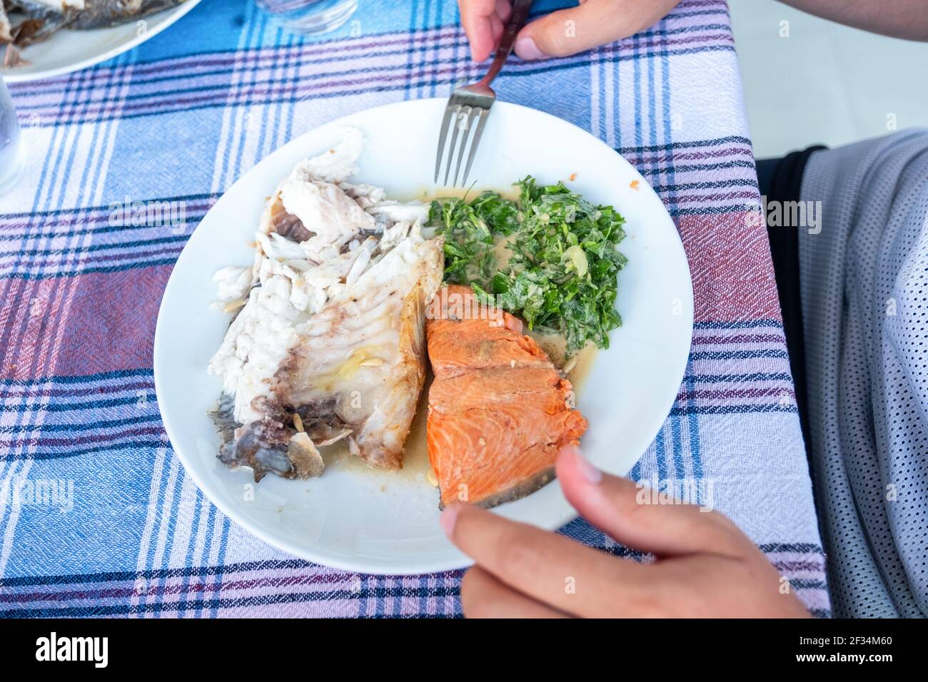 Family gathering to eat fish together Stock Photo - Alamy