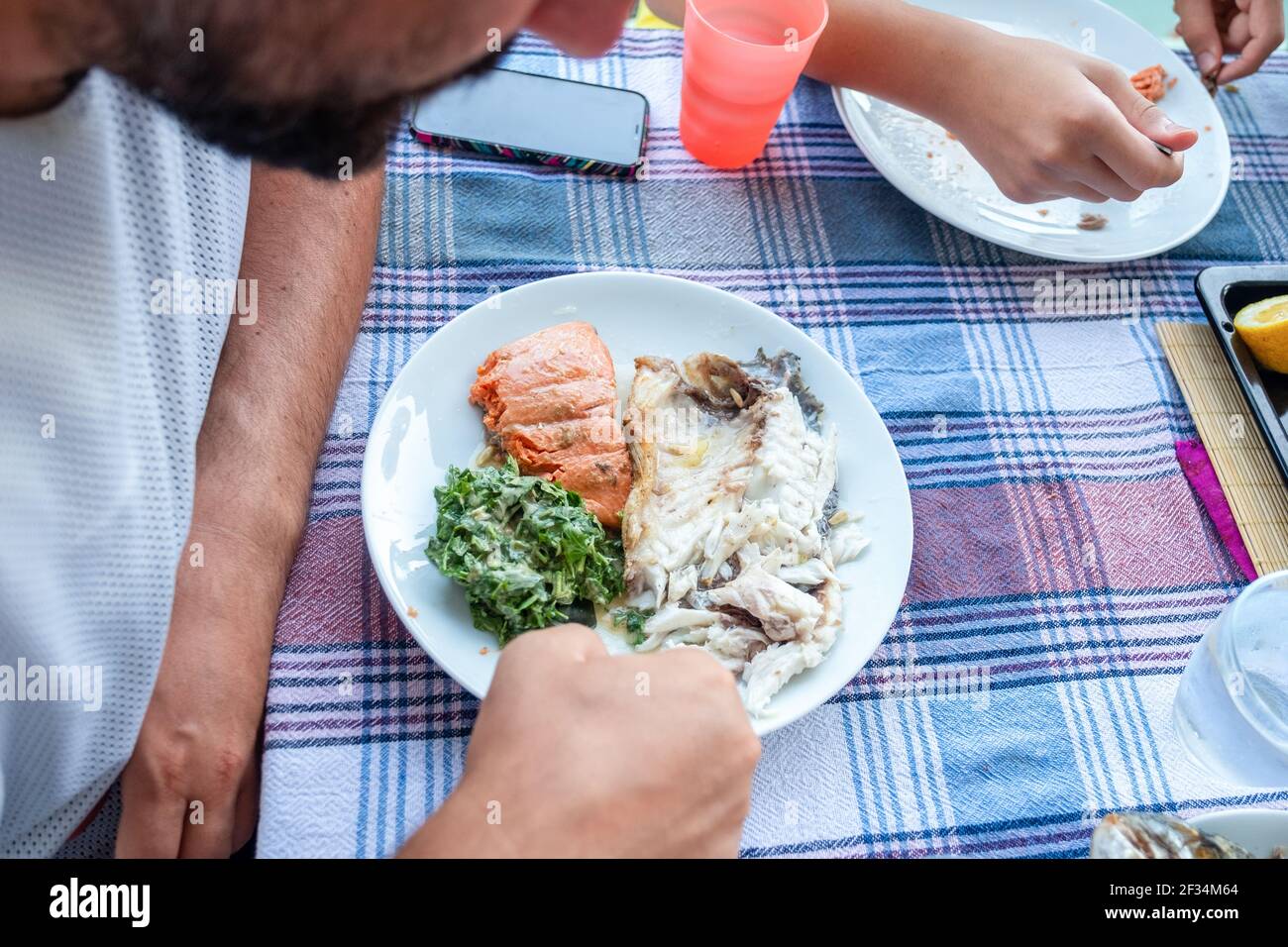 Family gathering to eat fish together Stock Photo - Alamy