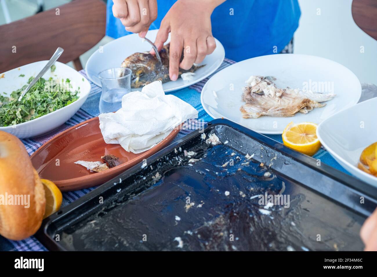 Family gathering to eat fish together Stock Photo - Alamy