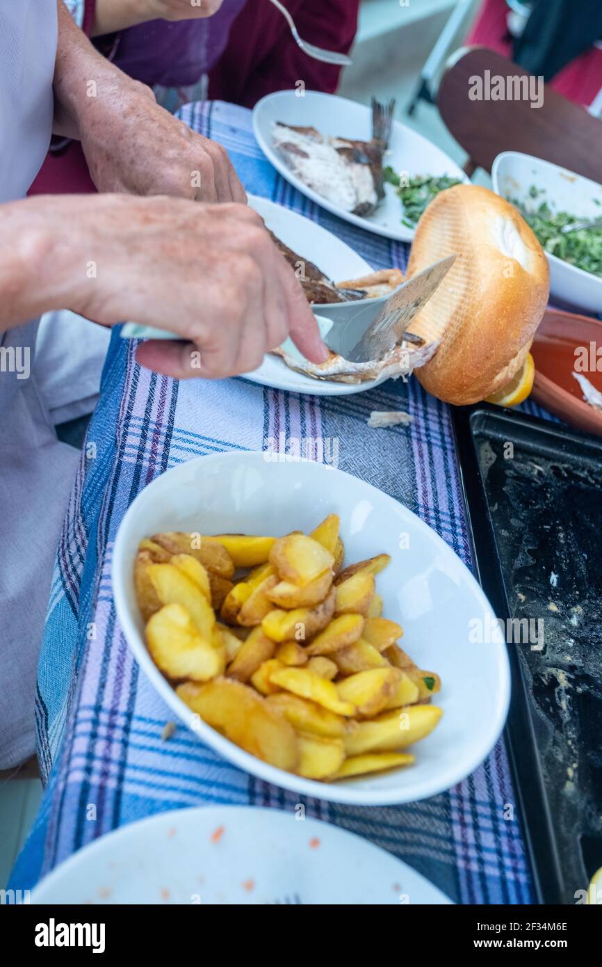 Family gathering to eat fish together Stock Photo - Alamy