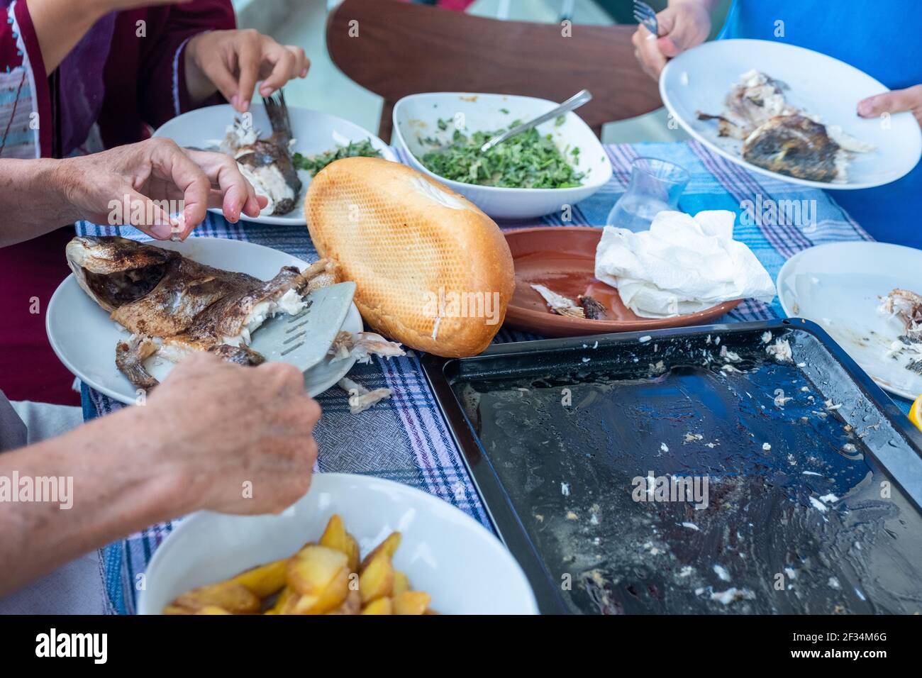 Family gathering to eat fish together Stock Photo - Alamy