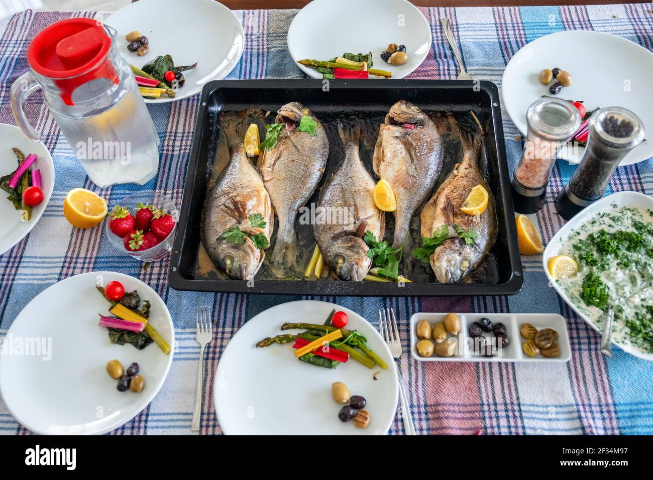 Family gathering to eat fish together Stock Photo - Alamy