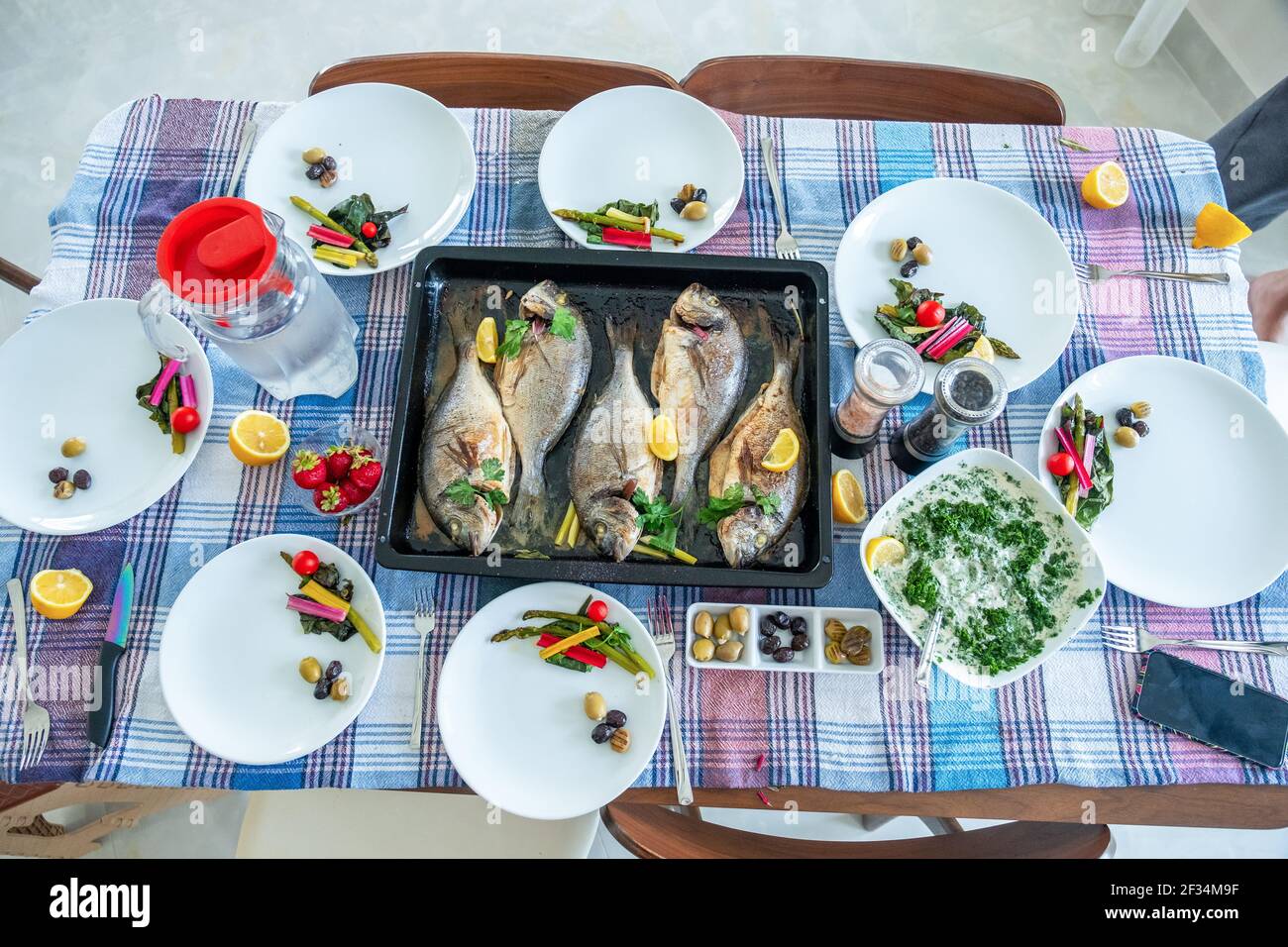 Family gathering to eat fish together Stock Photo - Alamy