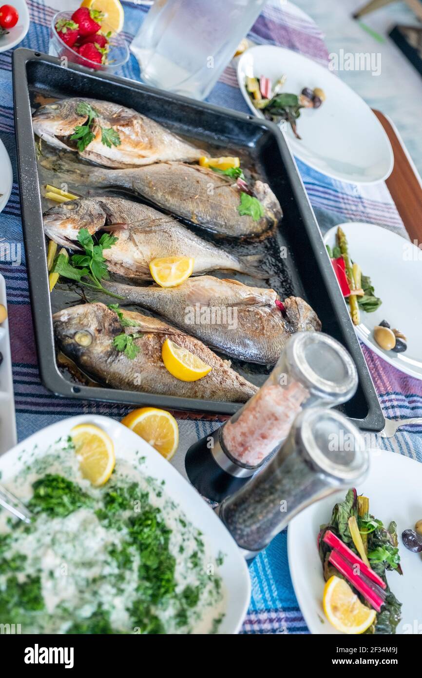Family gathering to eat fish together Stock Photo - Alamy