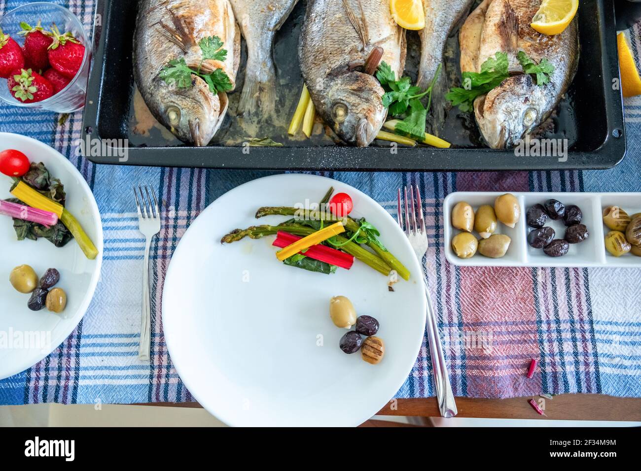 Family gathering to eat fish together Stock Photo - Alamy