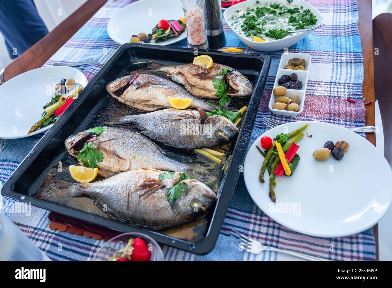 Family gathering to eat fish together Stock Photo - Alamy