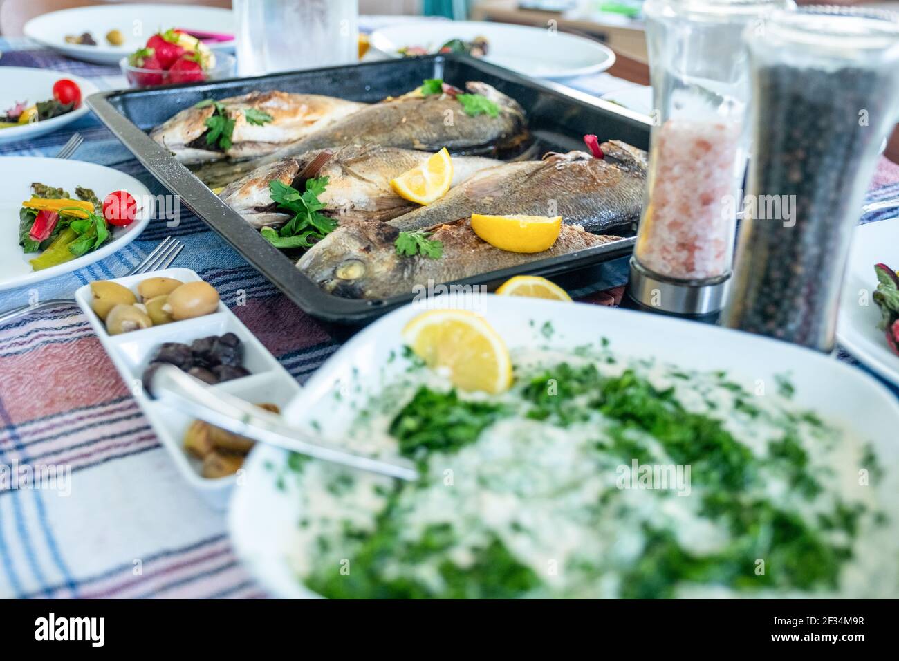 Family gathering to eat fish together Stock Photo - Alamy