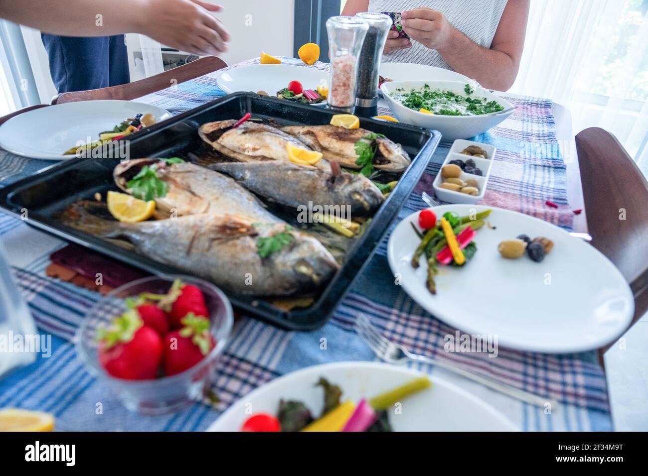 Family gathering to eat fish together Stock Photo - Alamy