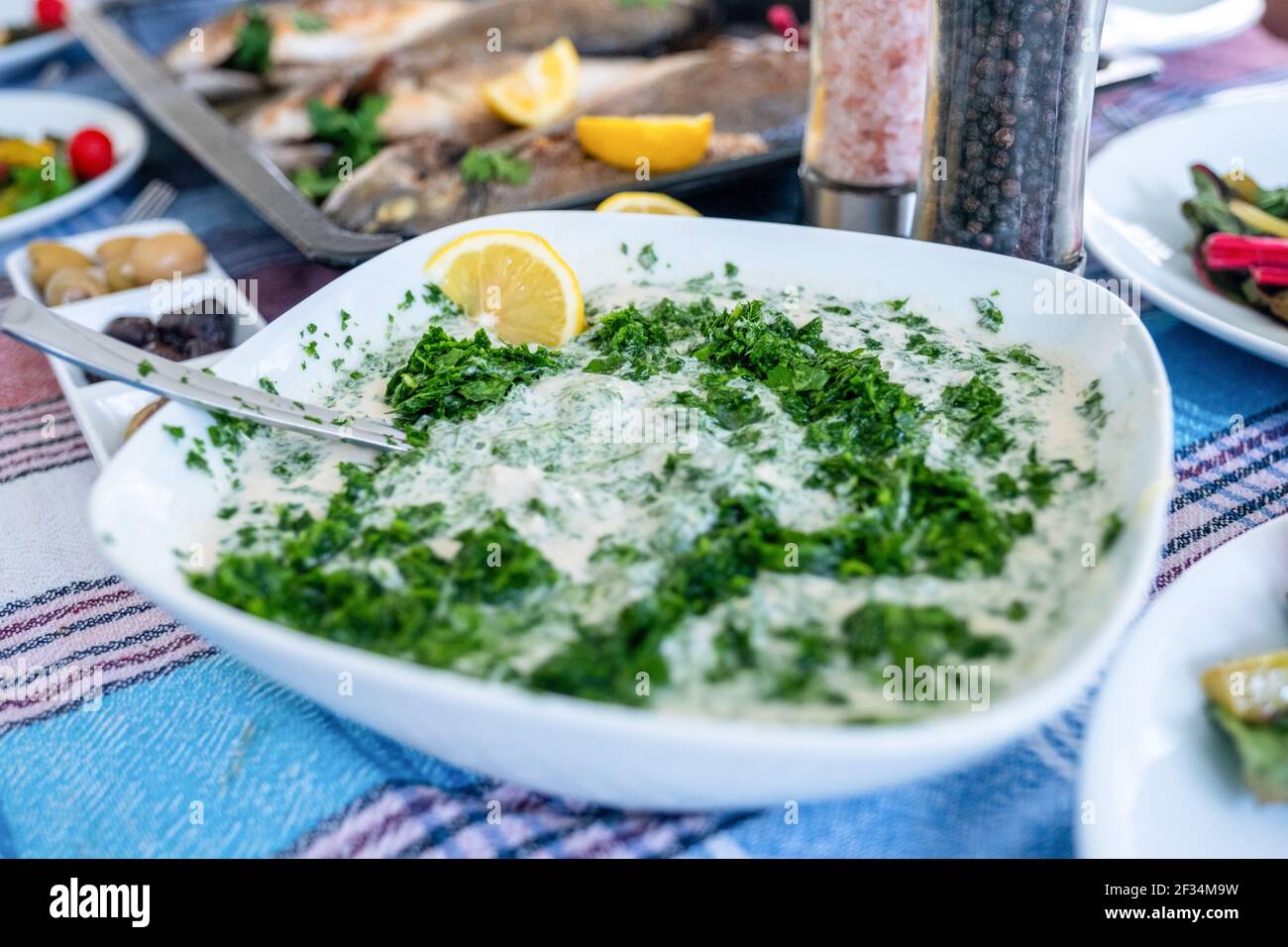 Family gathering to eat fish together Stock Photo - Alamy