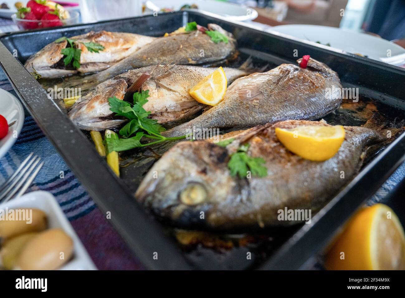 Family gathering to eat fish together Stock Photo - Alamy
