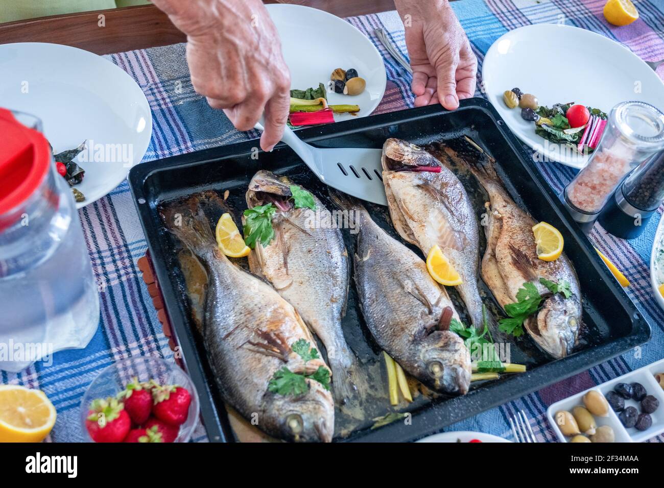 Family gathering to eat fish together Stock Photo - Alamy