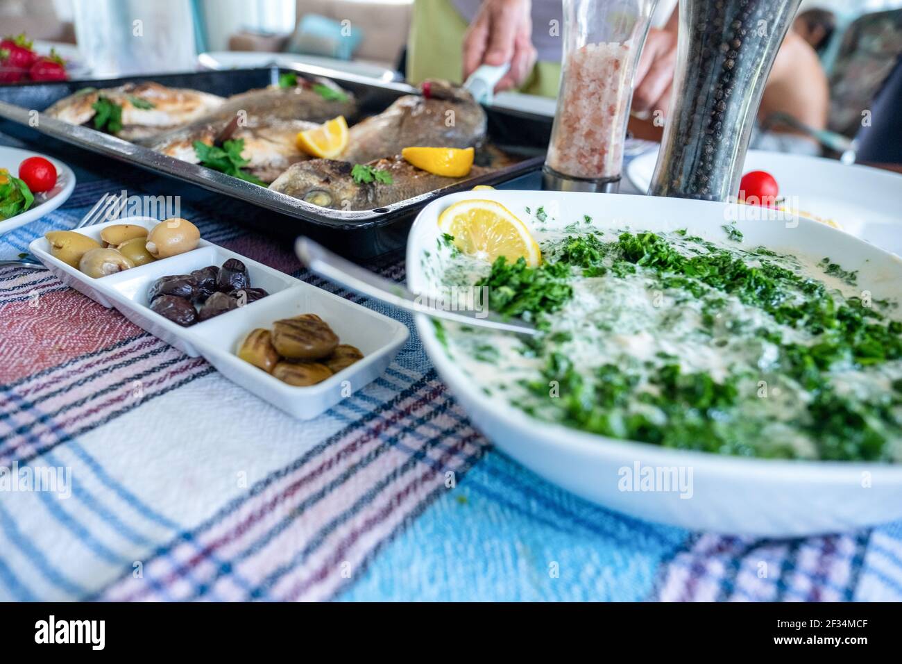 Family gathering to eat fish together Stock Photo - Alamy