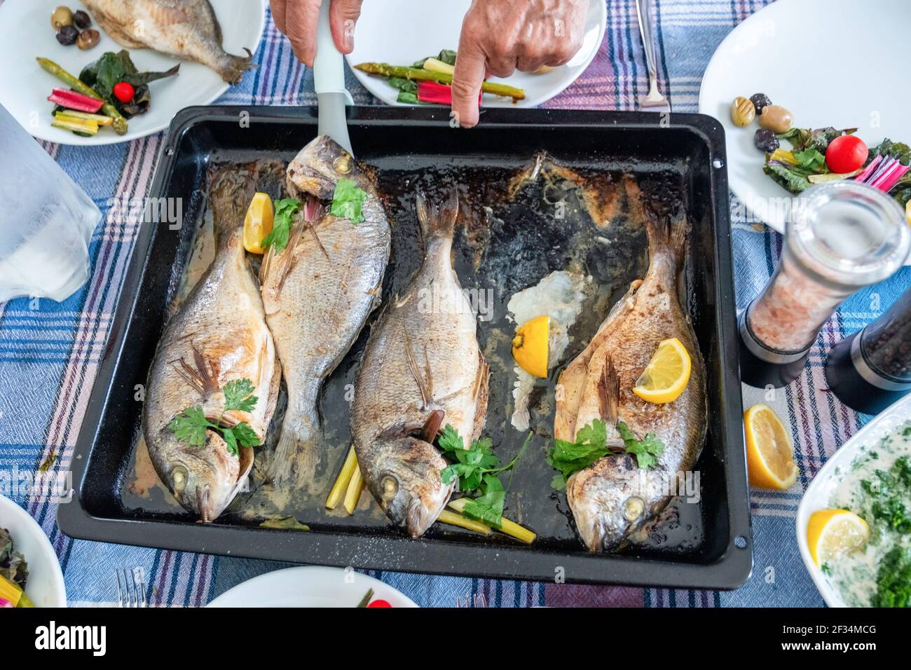 Family gathering to eat fish together Stock Photo - Alamy