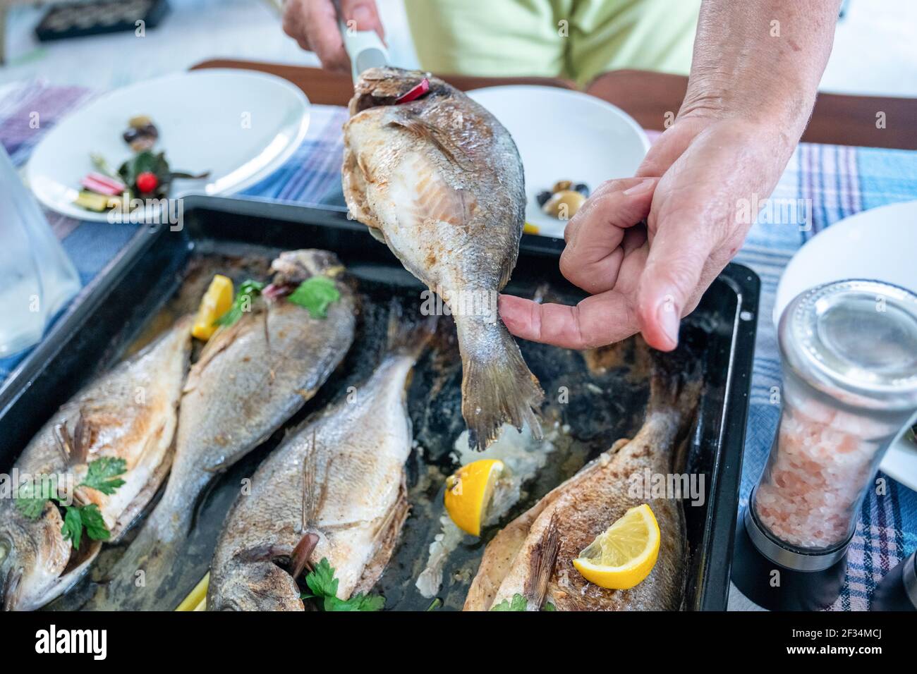 Family gathering to eat fish together Stock Photo - Alamy