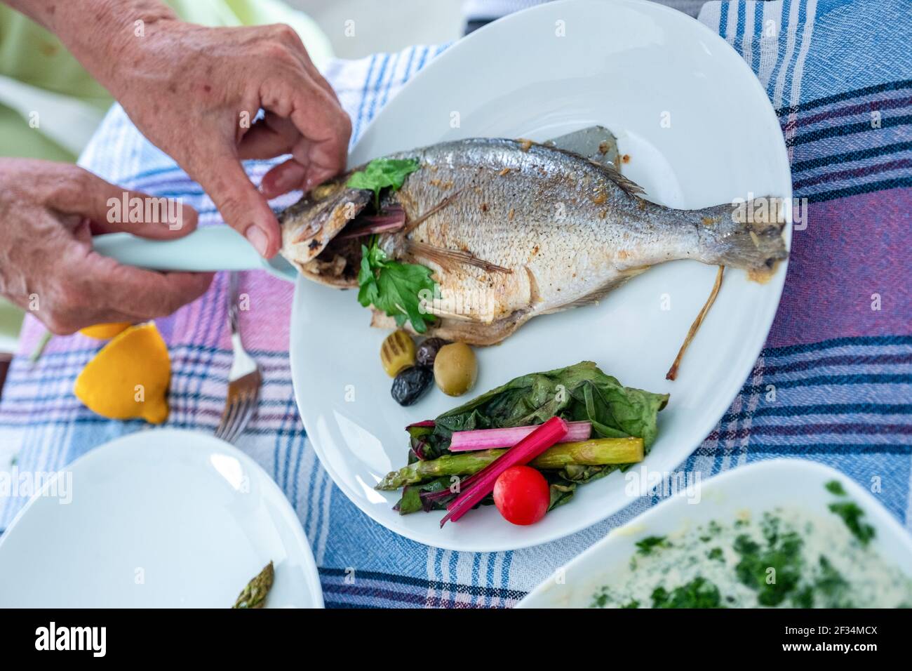 Family gathering to eat fish together Stock Photo - Alamy