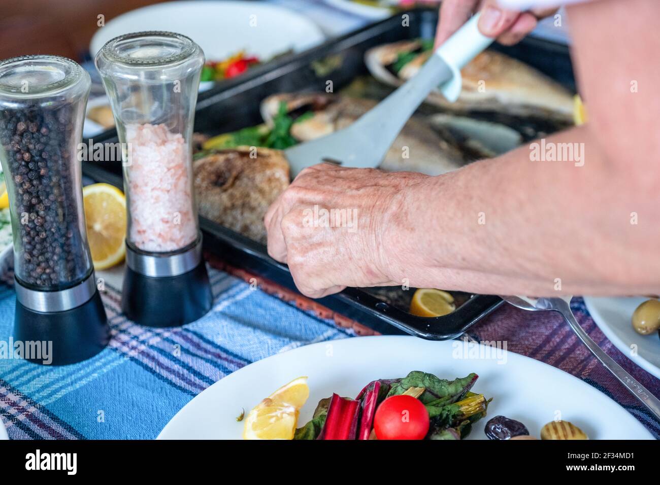 Family gathering to eat fish together Stock Photo - Alamy