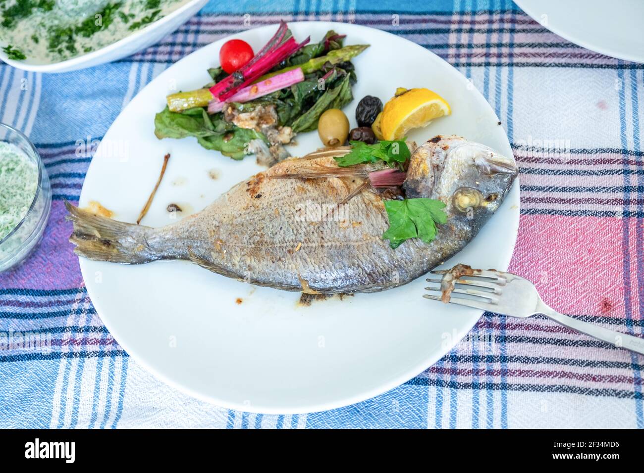 Family gathering to eat fish together Stock Photo - Alamy