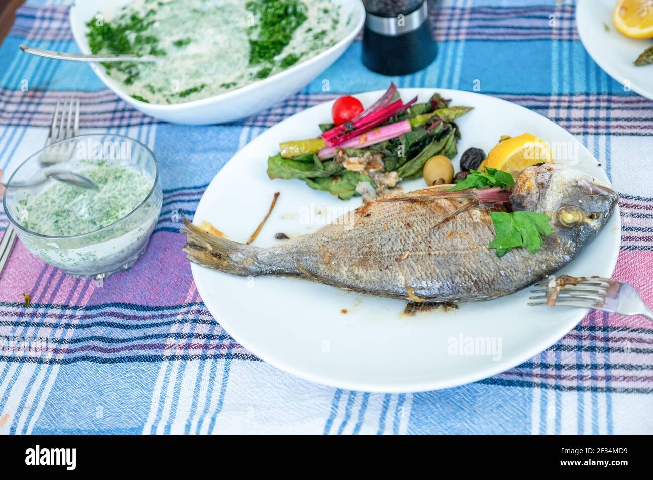 Family gathering to eat fish together Stock Photo - Alamy