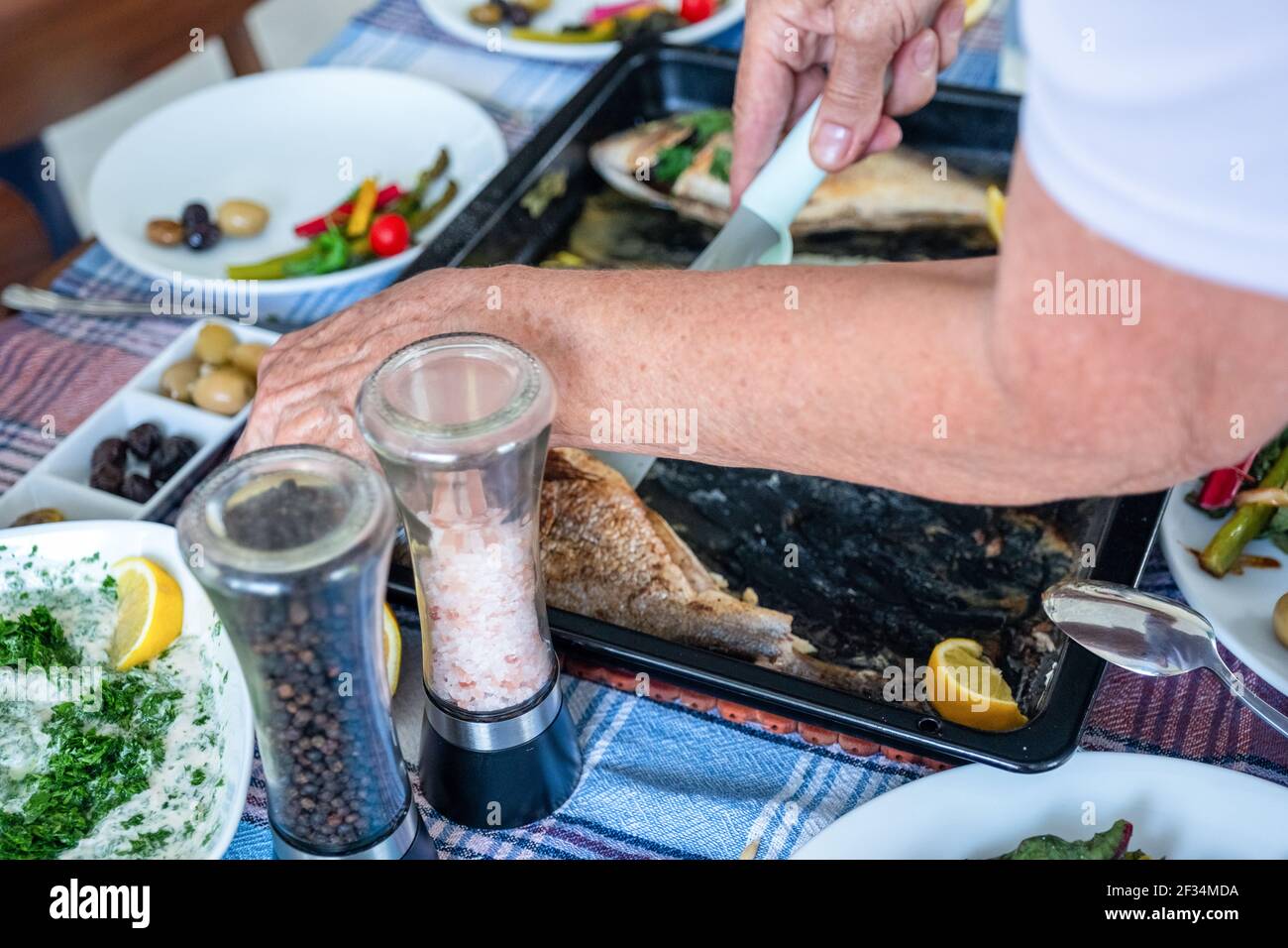 Family gathering to eat fish together Stock Photo - Alamy