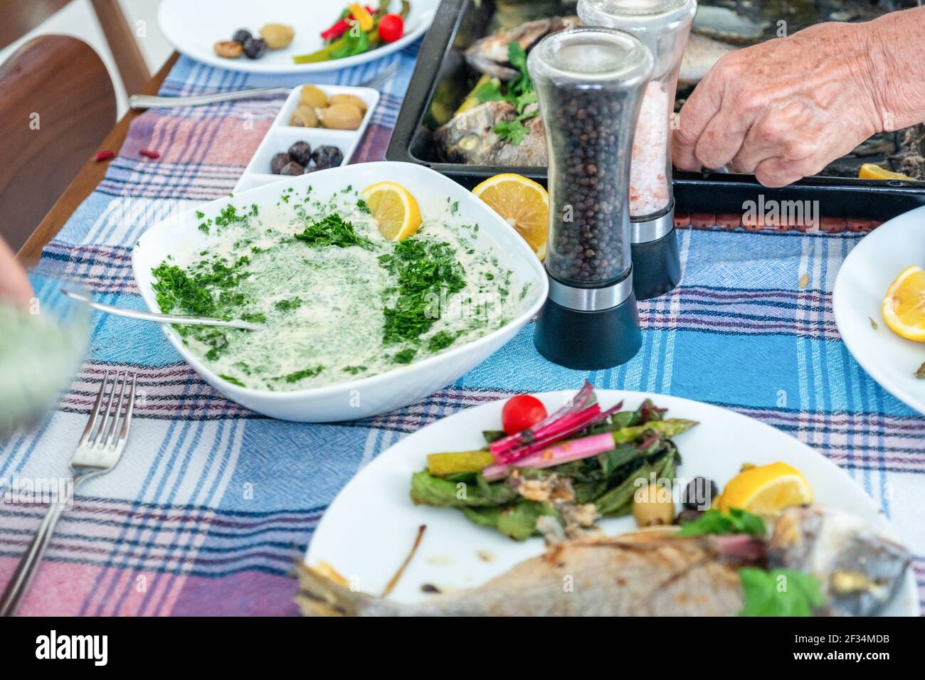 Family gathering to eat fish together Stock Photo - Alamy