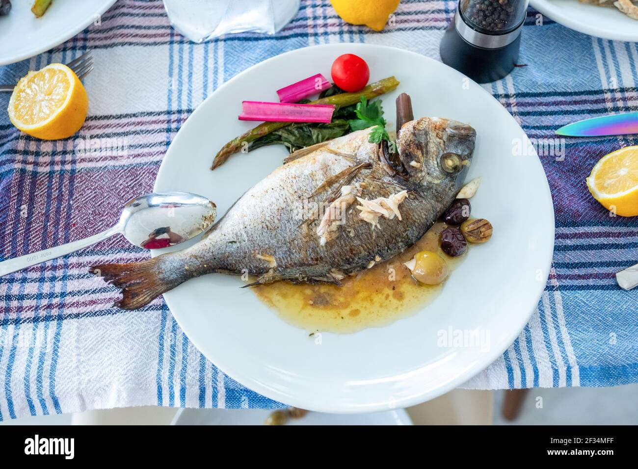 Family gathering to eat fish together Stock Photo - Alamy