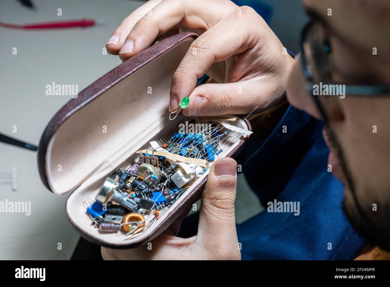 Guy holding electronic parts with his hand Stock Photo - Alamy