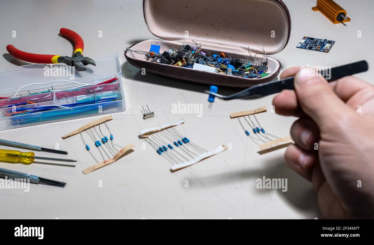 Guy holding electronic parts with his hand Stock Photo - Alamy