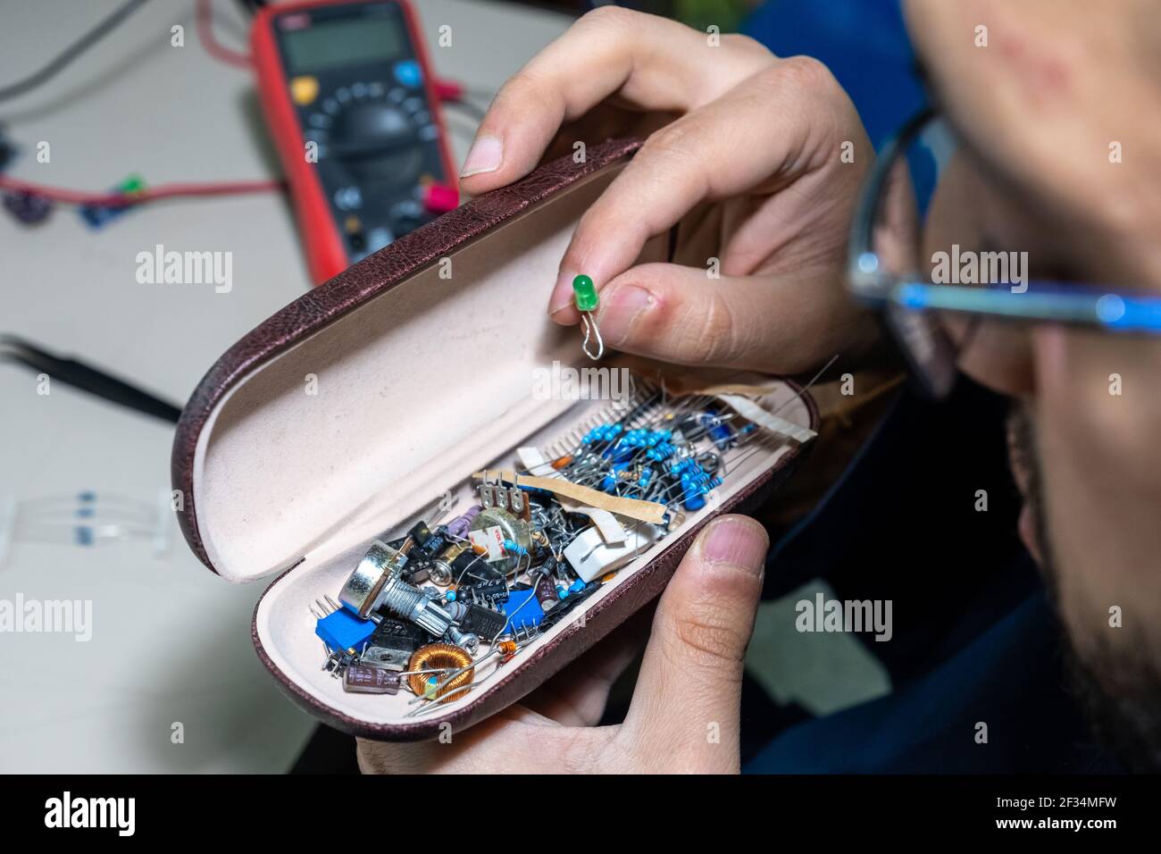 Guy holding electronic parts with his hand Stock Photo - Alamy