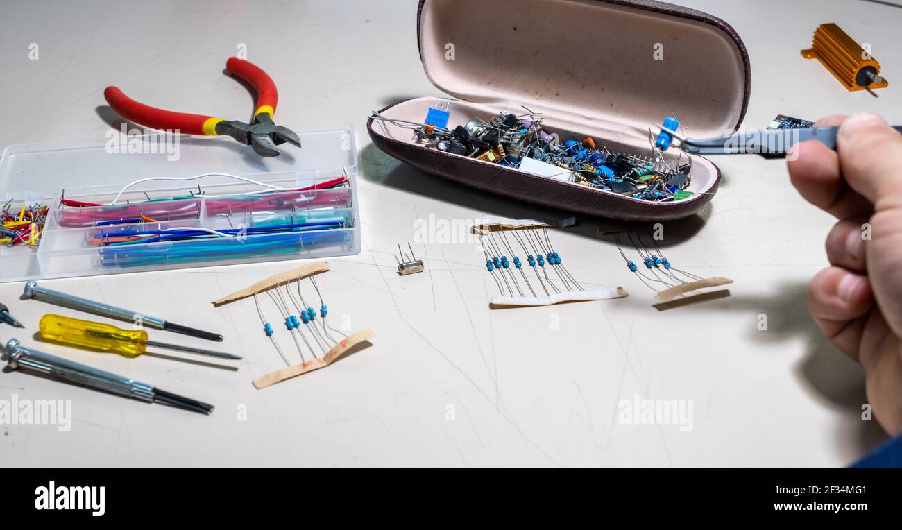 Guy holding electronic parts with his hand Stock Photo - Alamy