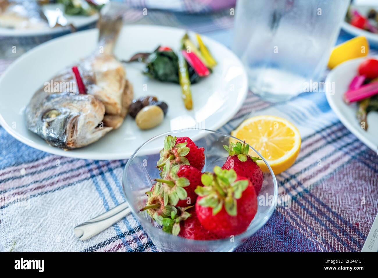 Family gathering to eat fish together Stock Photo - Alamy