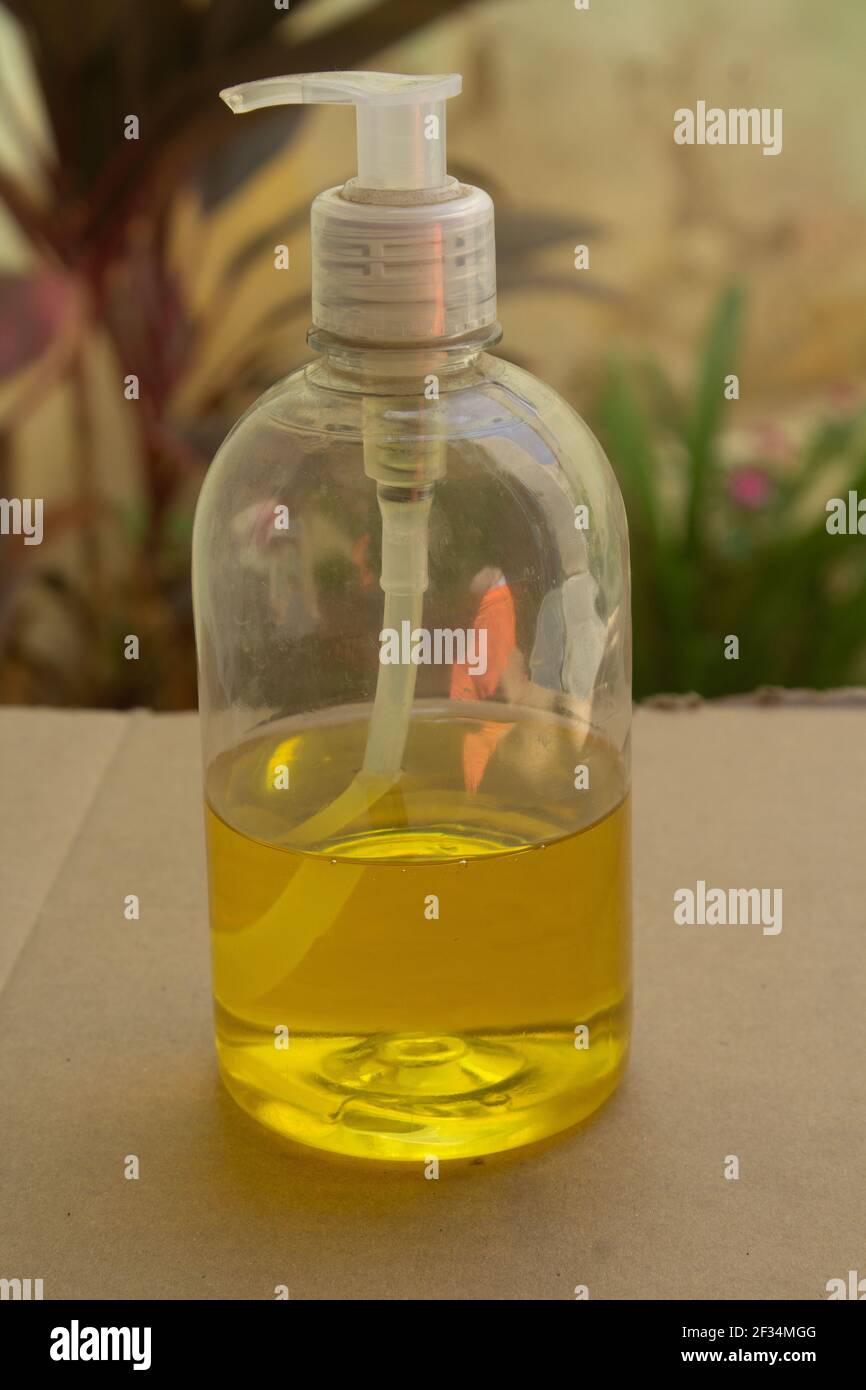 A closeup shot of a transparent bottle of yellow liquid soap Stock ...