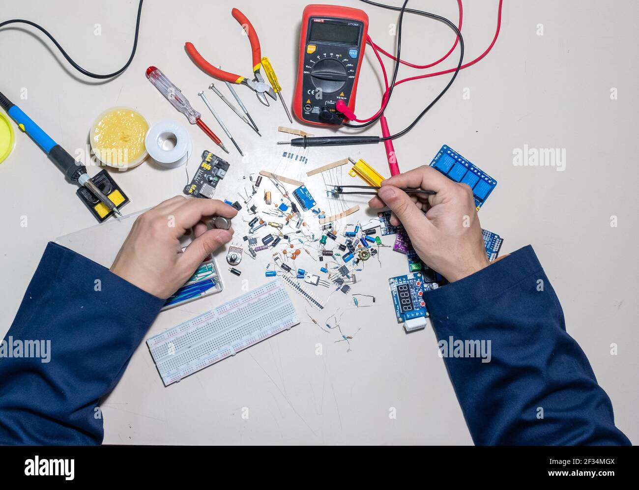 Guy holding electronic parts with his hand Stock Photo - Alamy