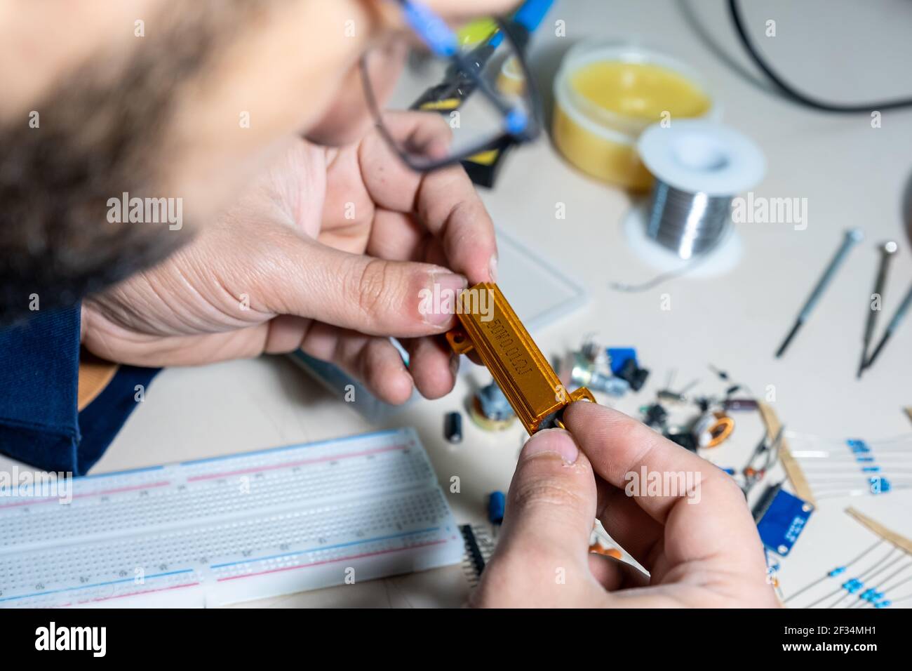 Guy holding electronic parts with his hand Stock Photo - Alamy