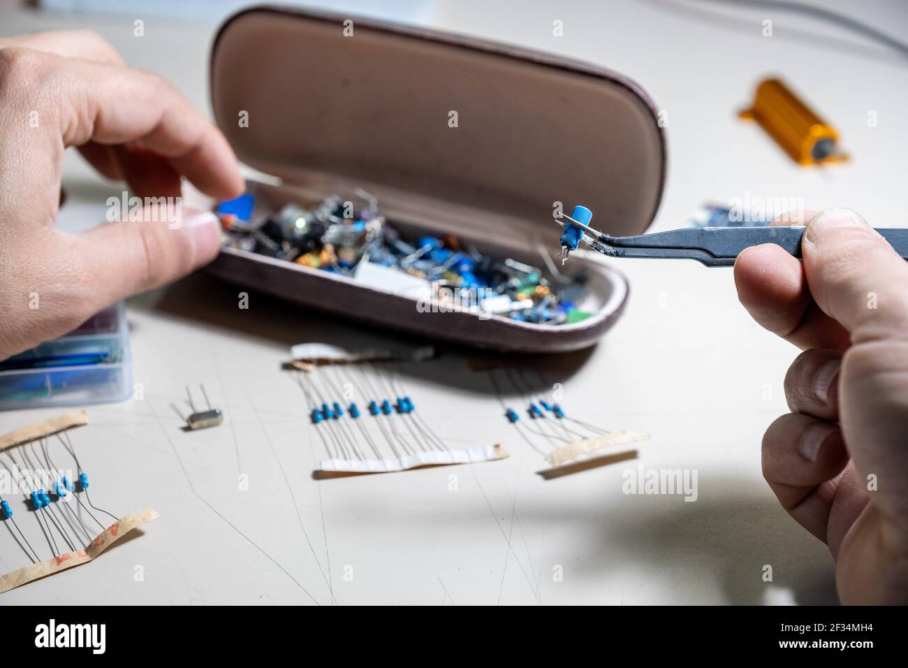 Guy holding electronic parts with his hand Stock Photo - Alamy