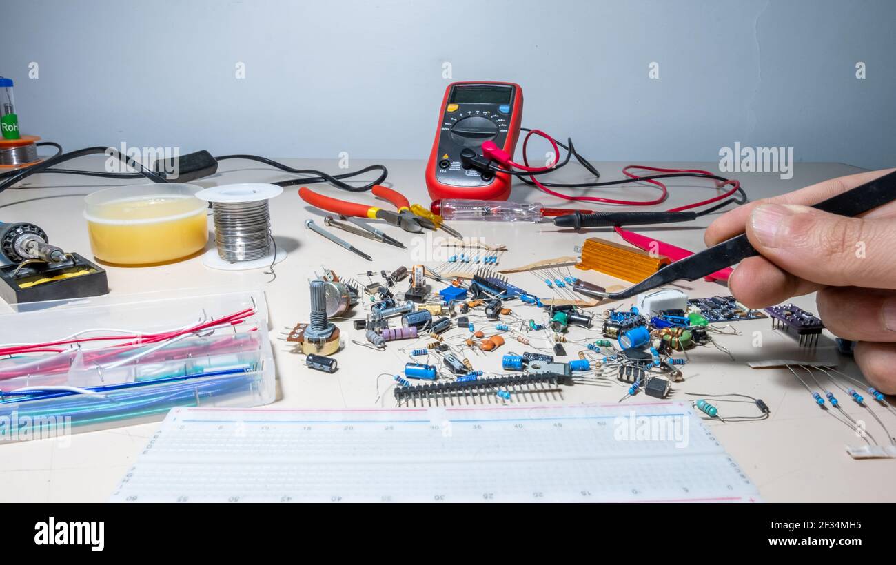 Guy holding electronic parts with his hand Stock Photo - Alamy