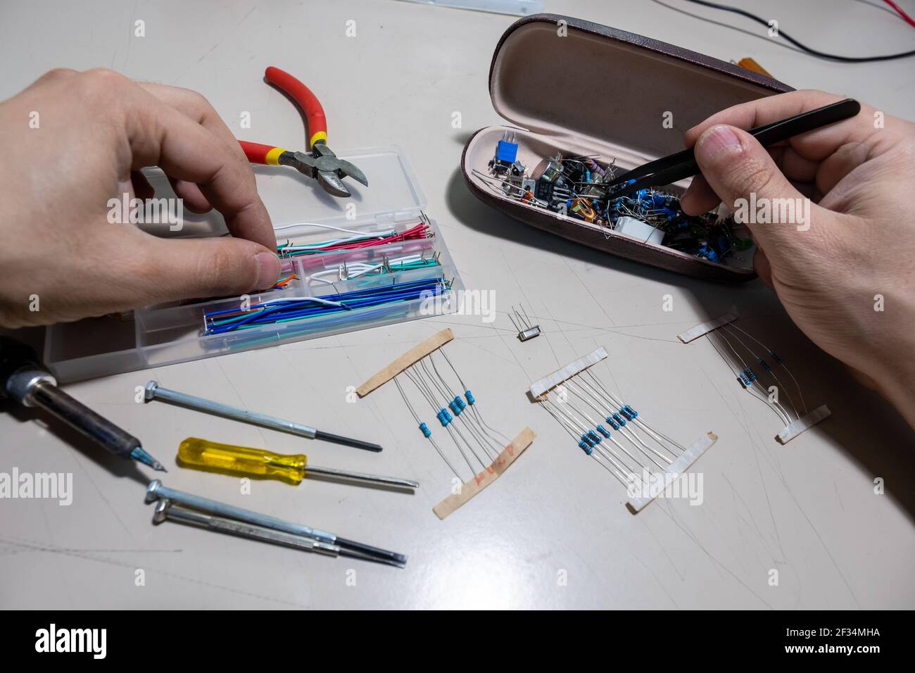 Guy holding electronic parts with his hand Stock Photo - Alamy
