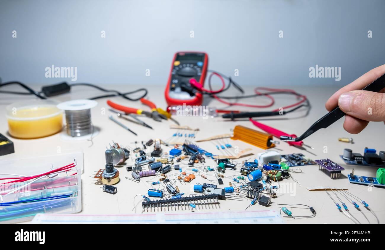 Guy holding electronic parts with his hand Stock Photo - Alamy