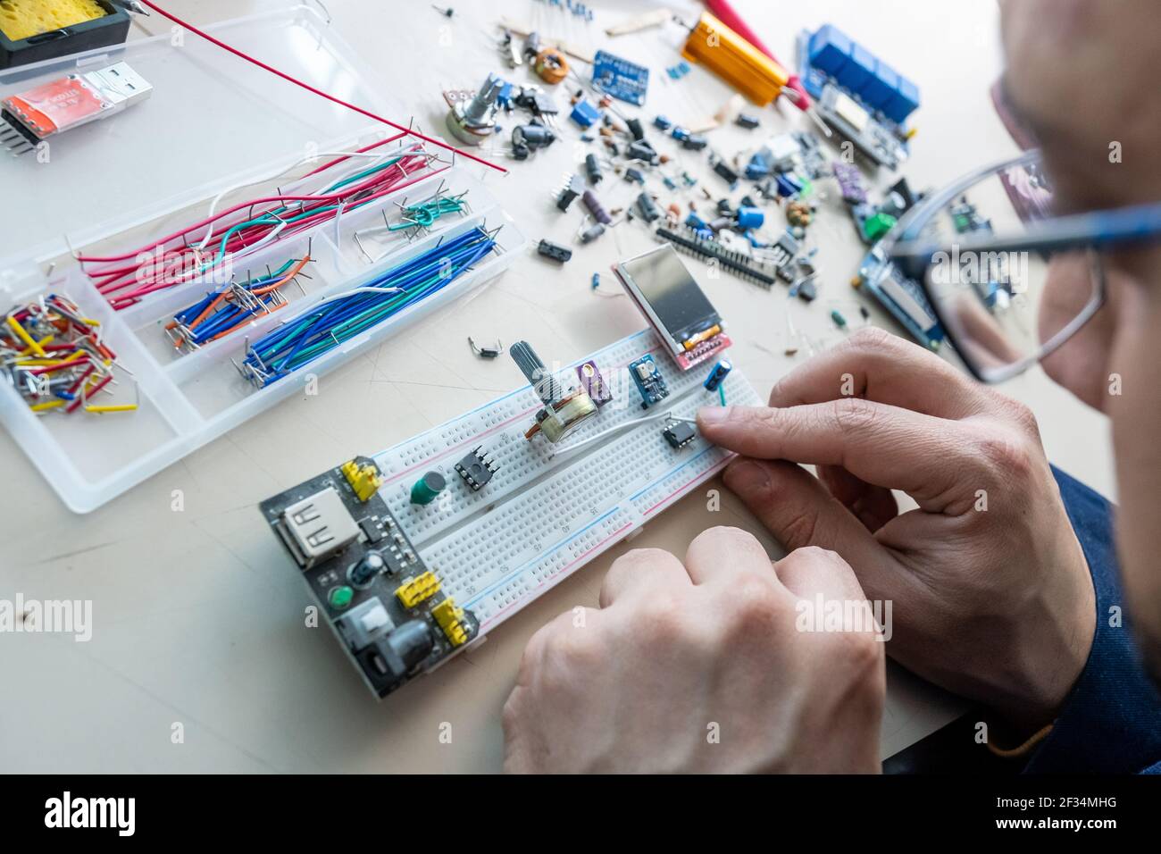 Guy holding electronic parts with his hand Stock Photo - Alamy