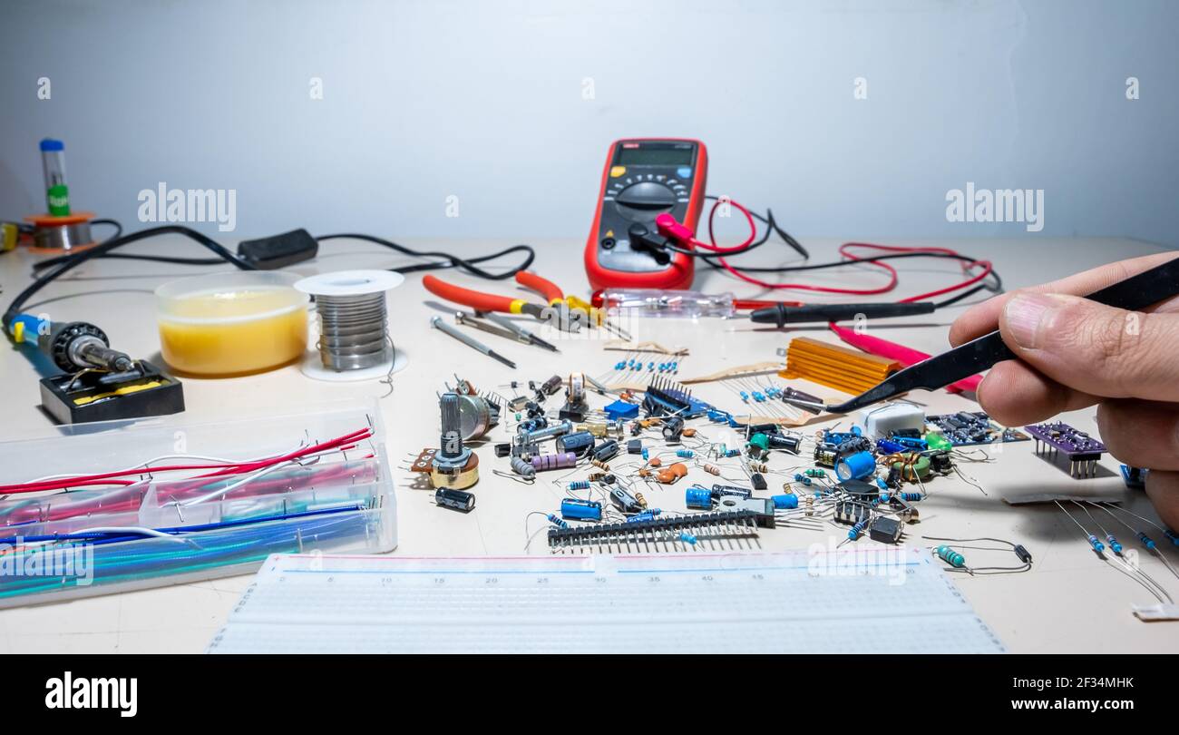 Guy holding electronic parts with his hand Stock Photo - Alamy