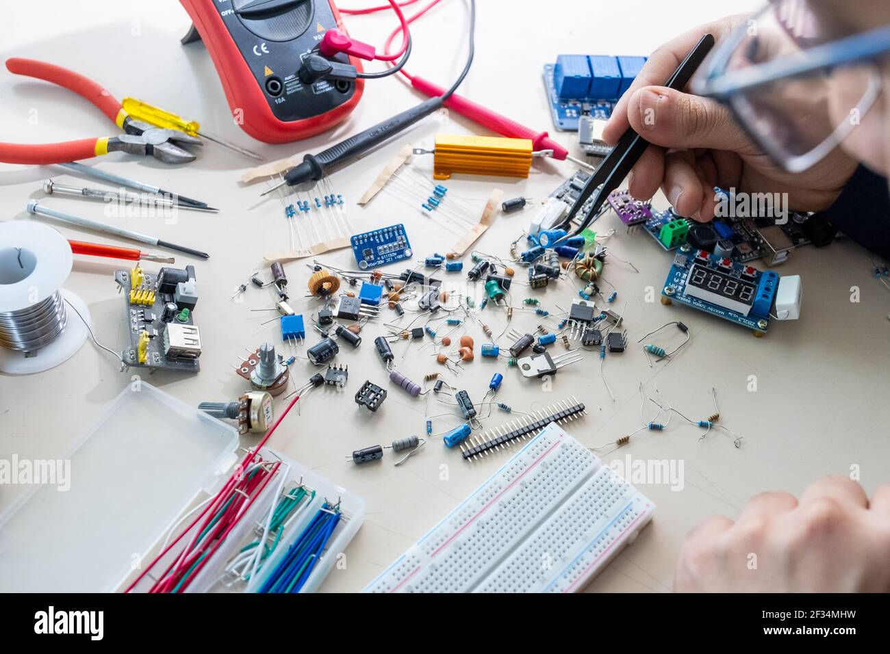 Guy holding electronic parts with his hand Stock Photo - Alamy