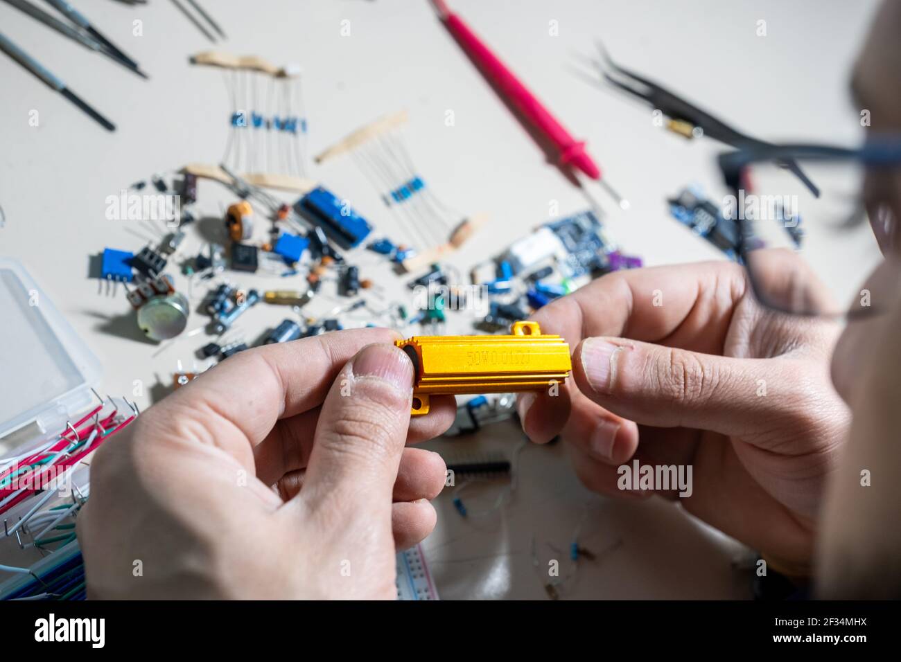 Guy holding electronic parts with his hand Stock Photo - Alamy