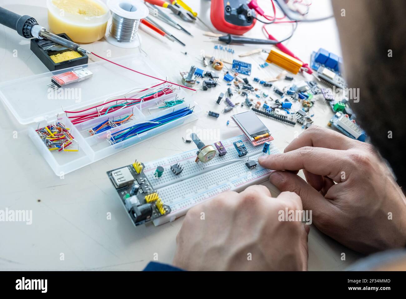 Guy holding electronic parts with his hand Stock Photo - Alamy