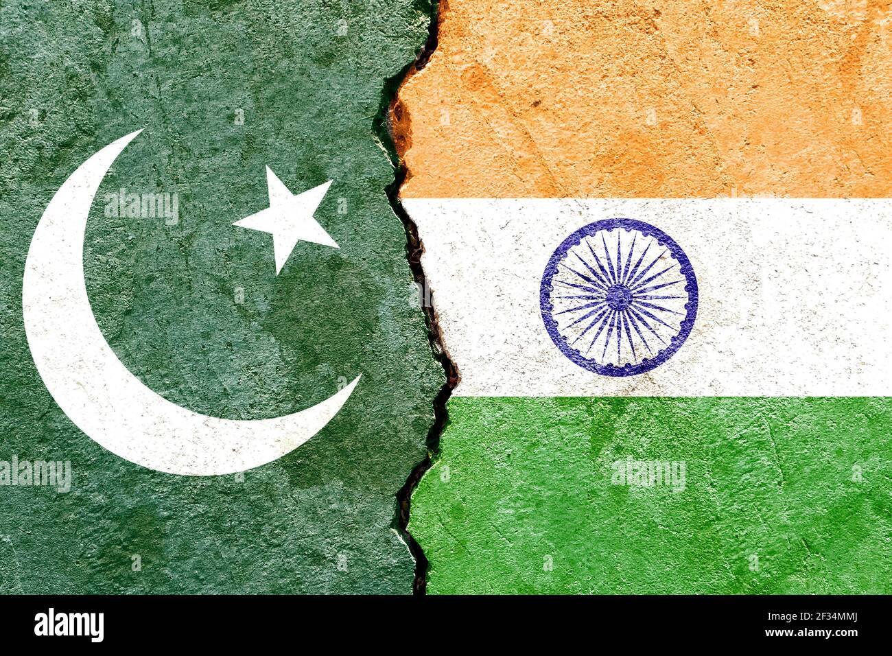 An overlay of the Pakistani and Indian flags on a weathered cracked ...