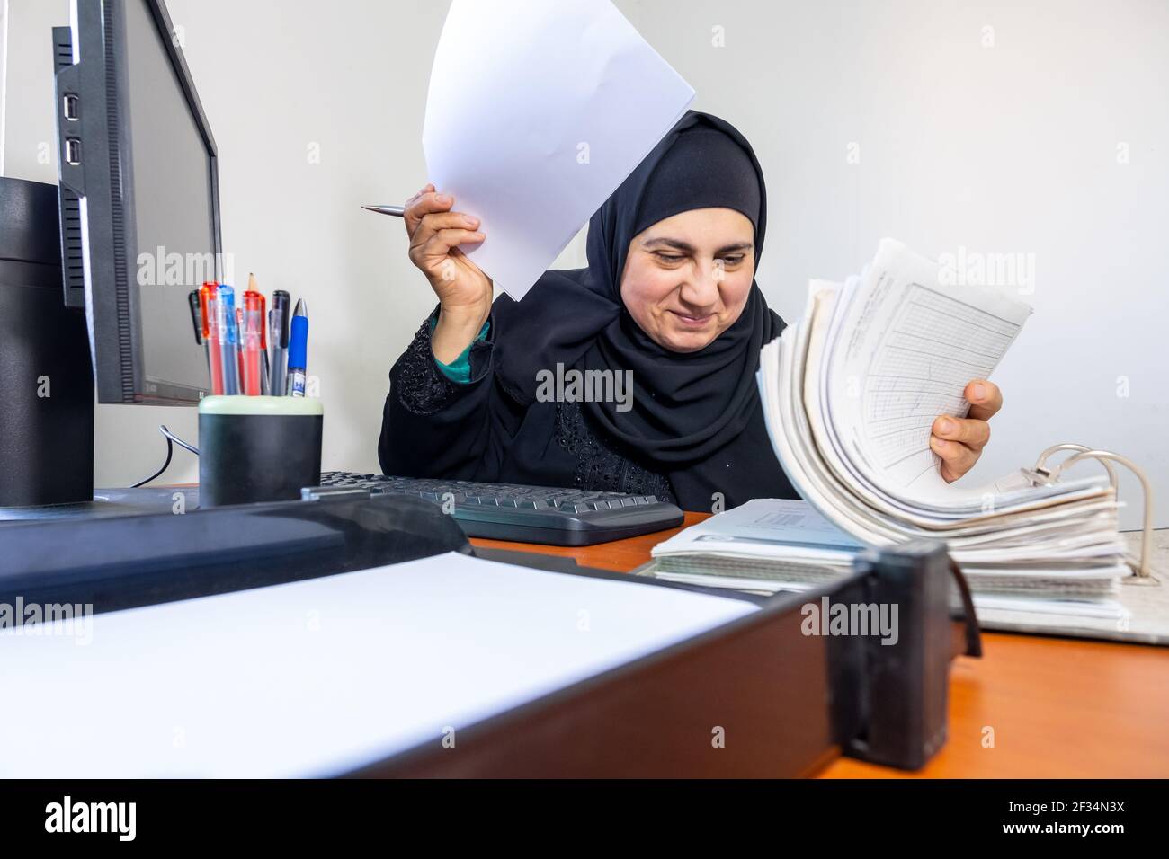 Muslim Arabic employee checking paper Stock Photo - Alamy