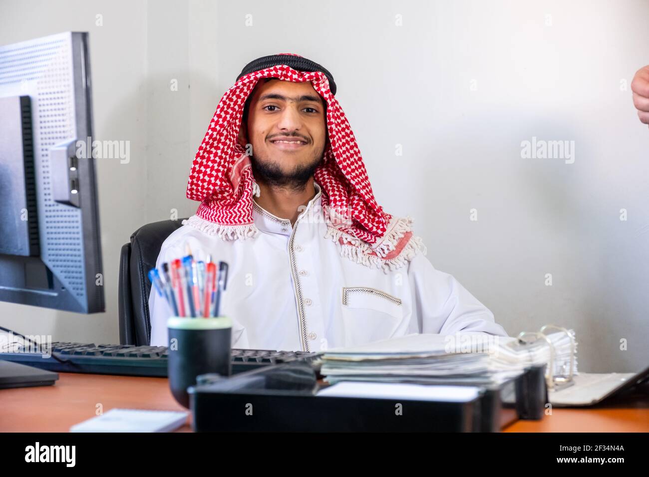 Arabic muslim employee happy at his workplace Stock Photo - Alamy