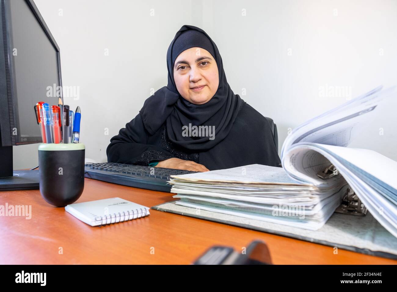 Muslim Arabic employee checking paper Stock Photo - Alamy