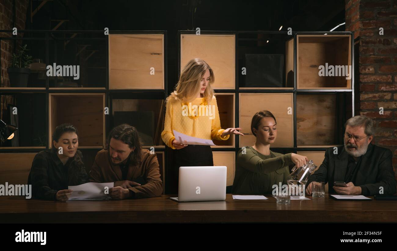 Anger. Young colleagues working together in a office styled like ...